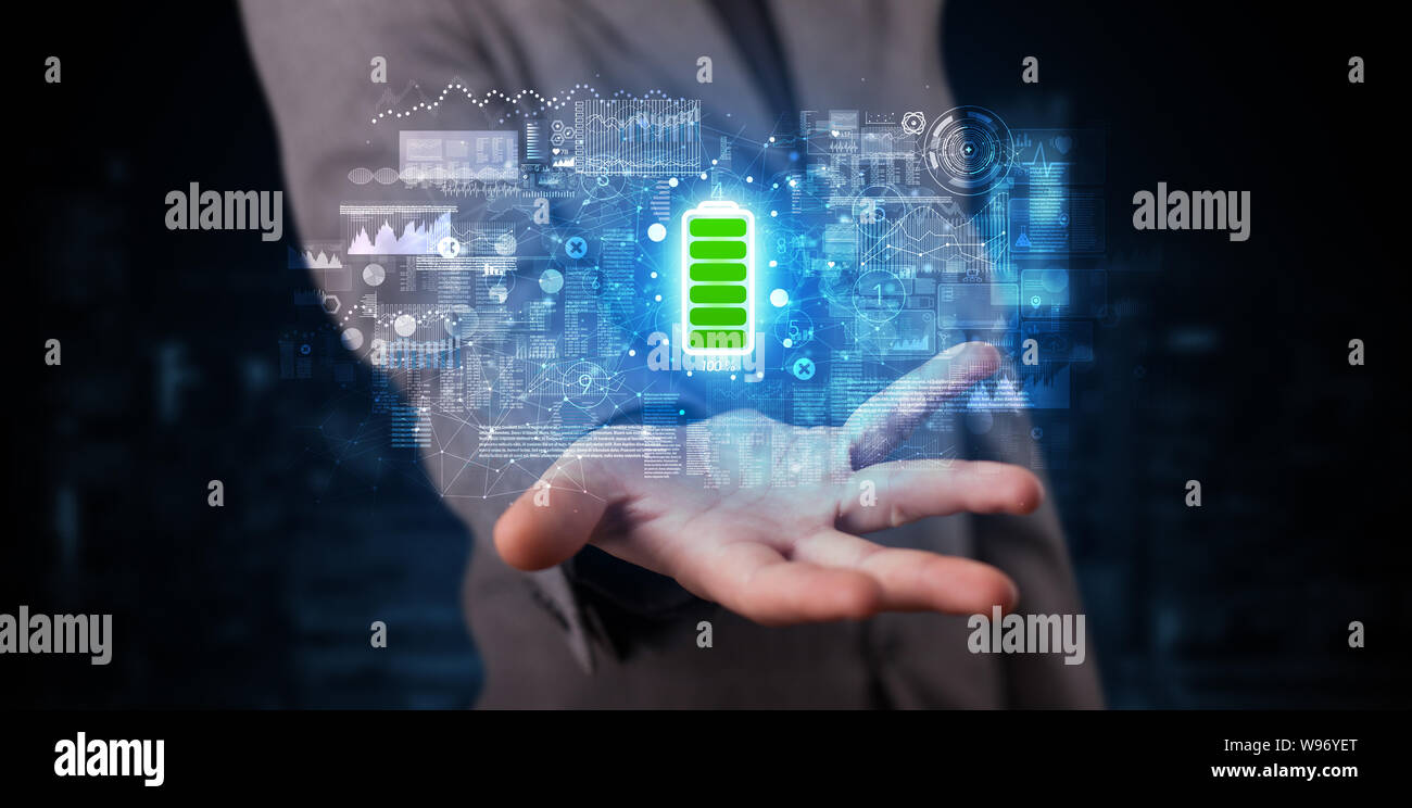 Elegant hand holding battery with full of energy Stock Photo - Alamy