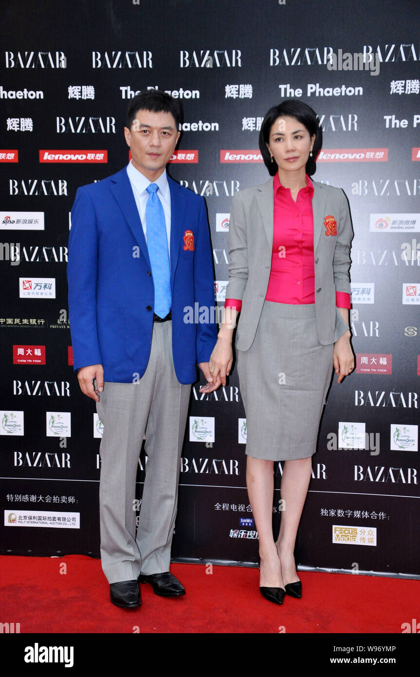 Hong Kong singer Faye Wong, right, and her actor husband Li Yapeng pose on the red carpet as ...