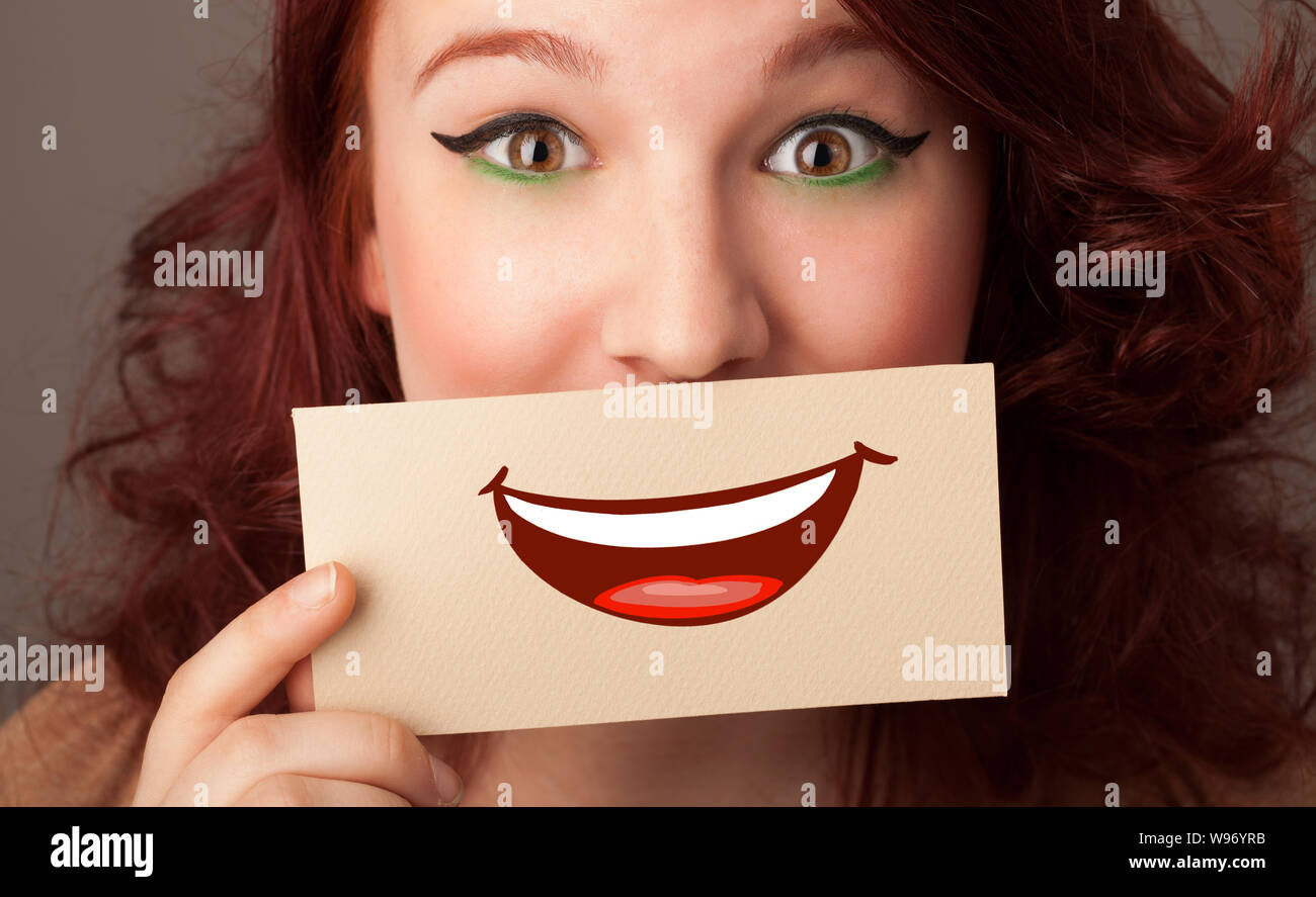 Person holding card in front of his mouth with ironic smile Stock Photo ...