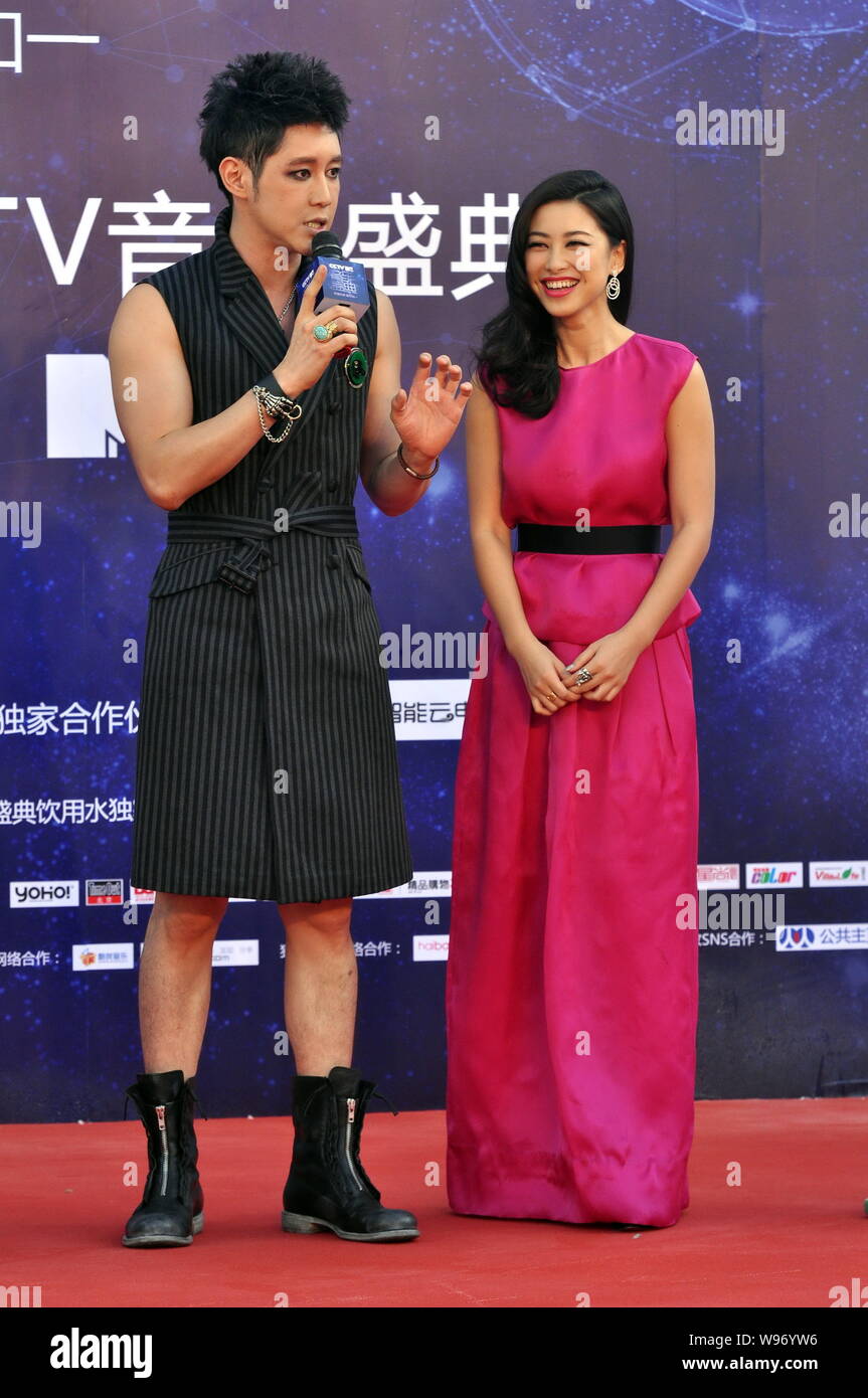 Taiwanese TV host Andy Chen, left, speaks next to Chinese actress Zhu Zhu, girlfriend of ...