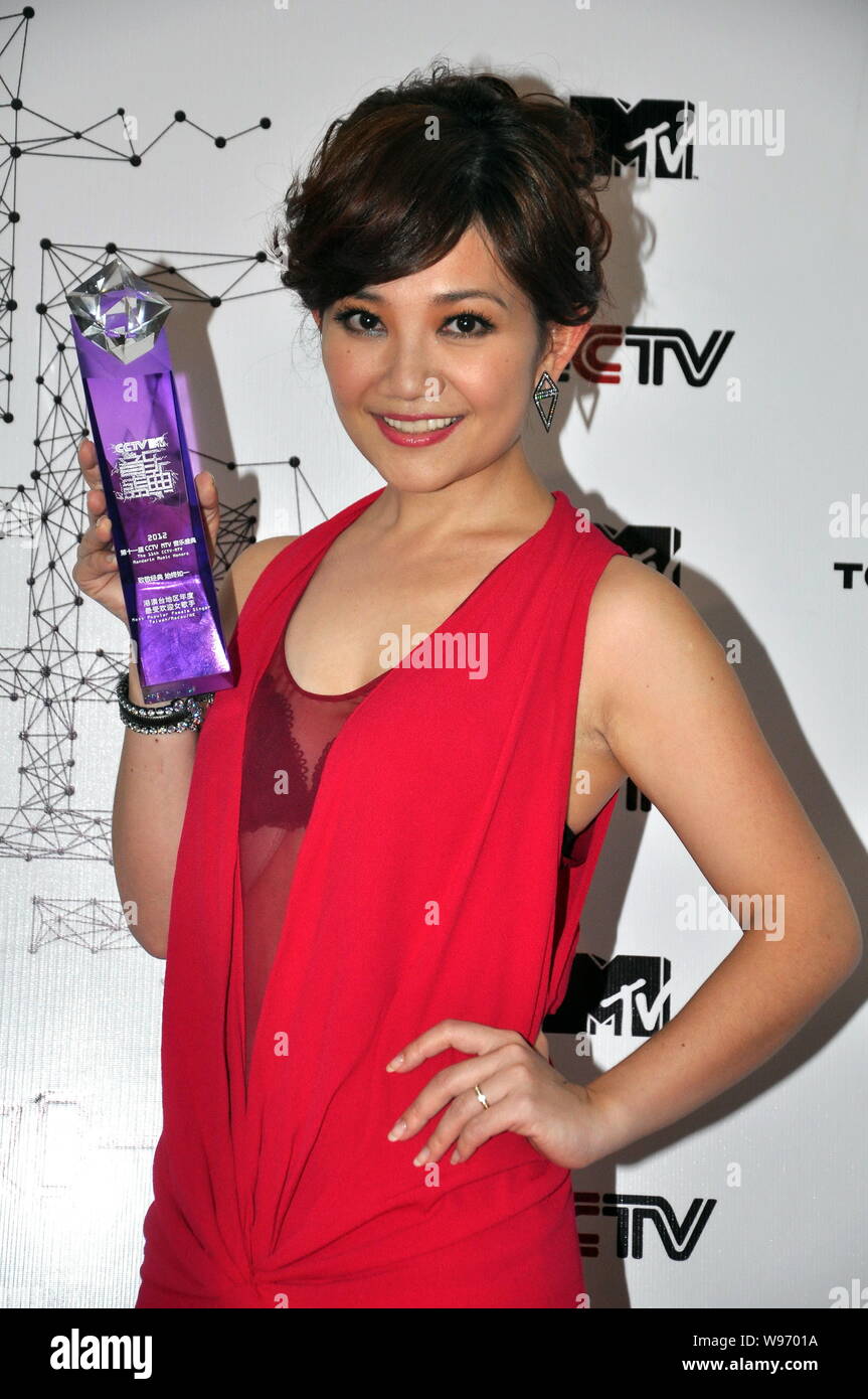 Malaysian singer Fish Leong holds her trophy for the most popular ...