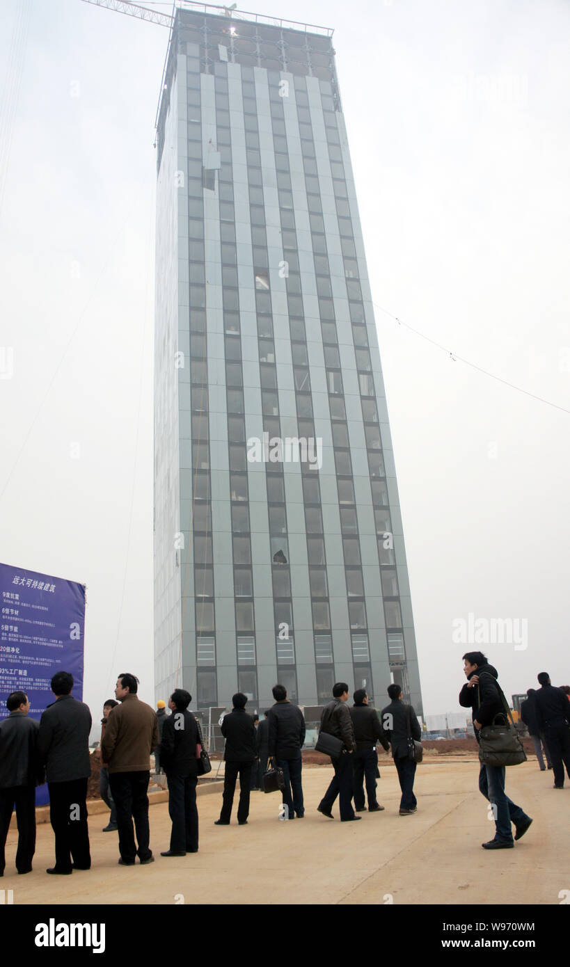 --FILE--Visitors look at the 30-storey New Ark Hotel which was built in ...