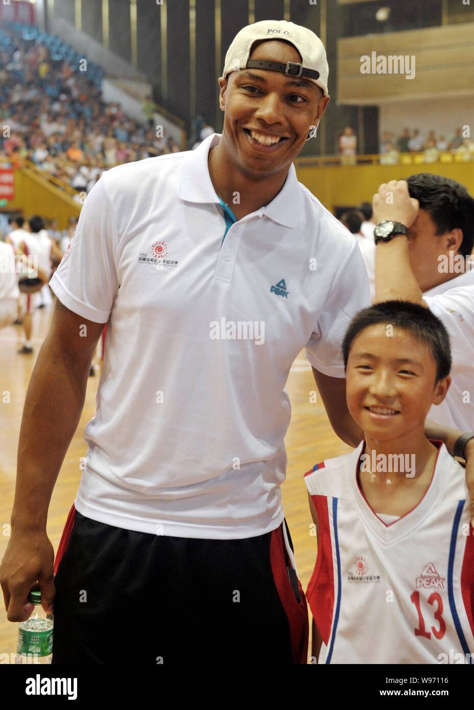 NBA star Caron Butler of the LA Clippers poses with a young basketball ...
