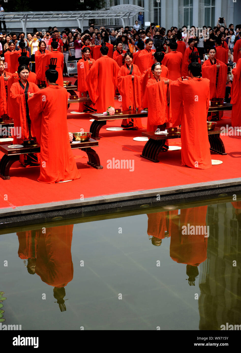 Couples of newlyweds dressed in traditional Han costumes bow to each ...