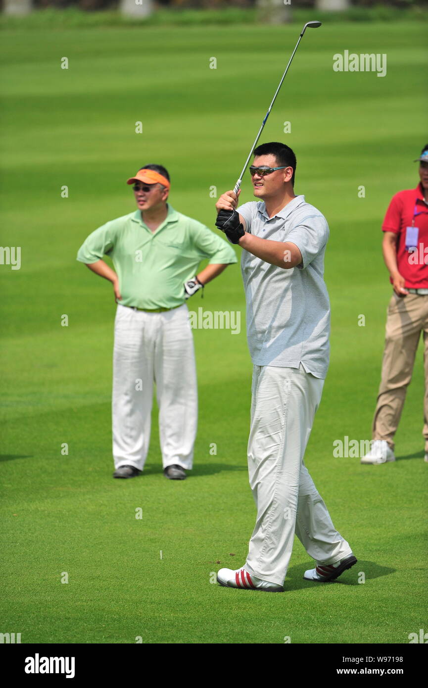 Retired Chinese basketball superstar Yao Ming, front, plays a shot ...