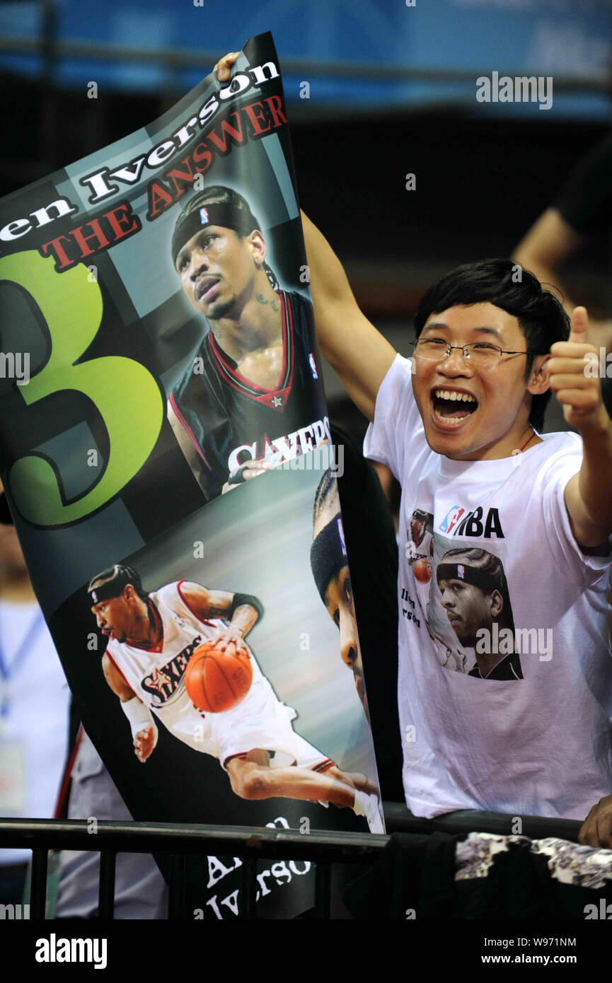A Chinese basketball fan holds up a poster to show support for NBA star ...