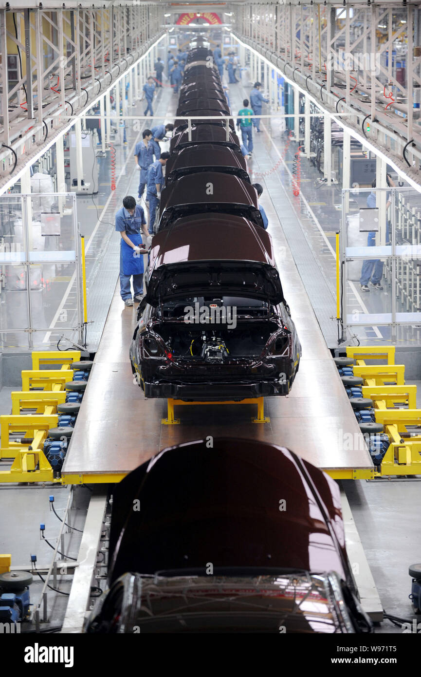 Chinese factory workers assemble Emgrand cars on the assembly line at ...