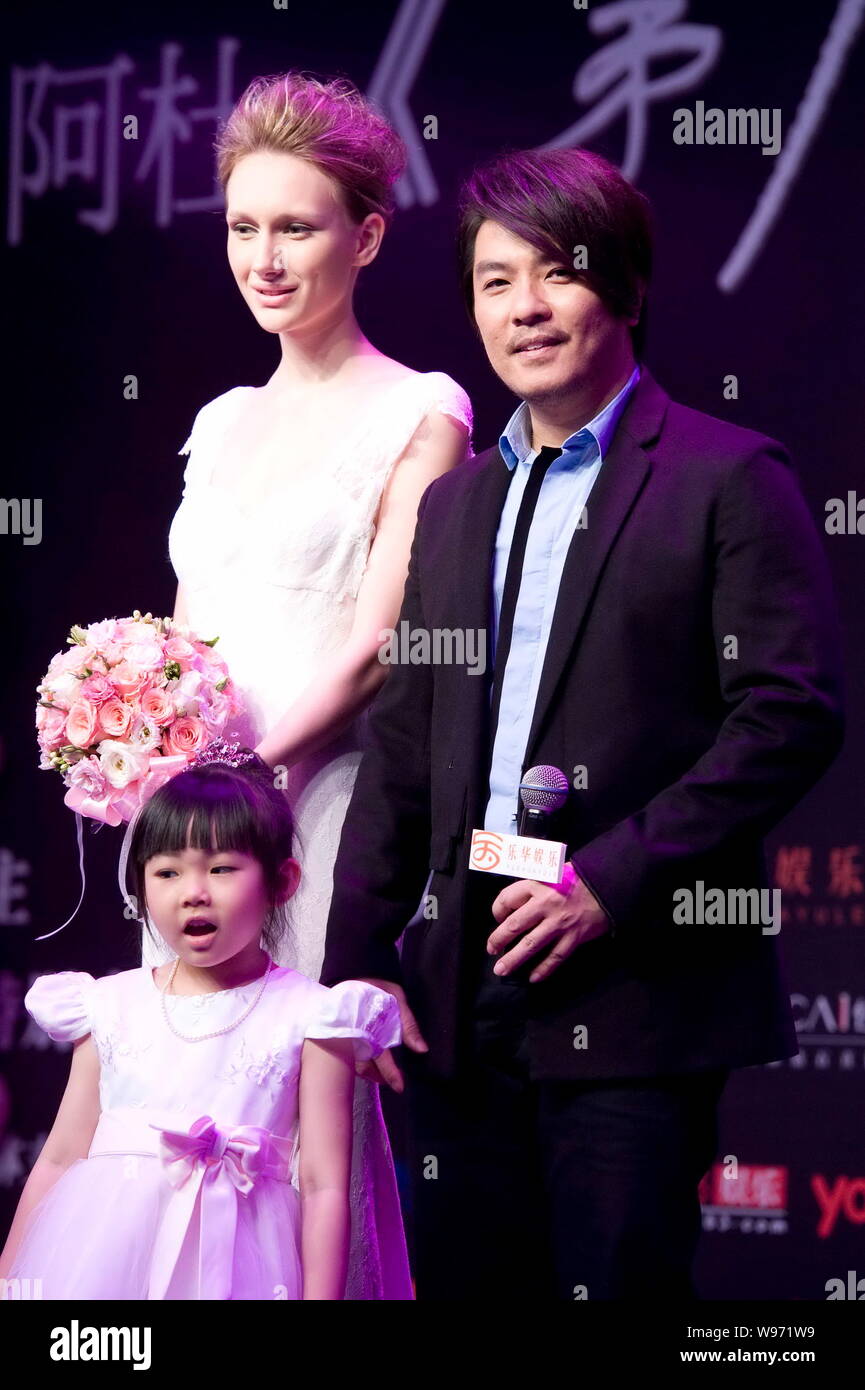 Singaporean singer Ado, right back, poses with models during his ...