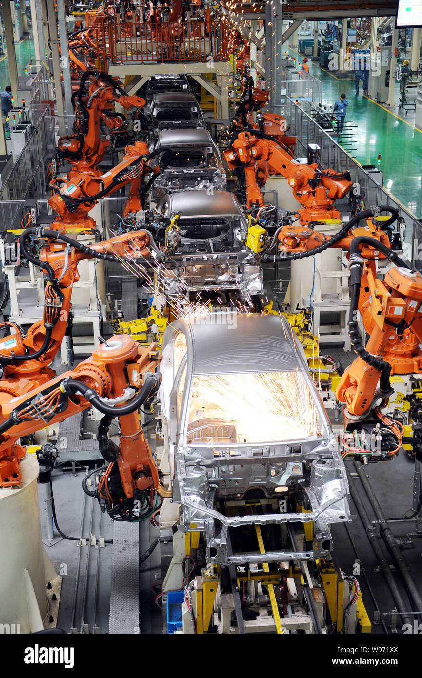 Robots weld bodies of Emgrand cars on the assembly line at an auto ...