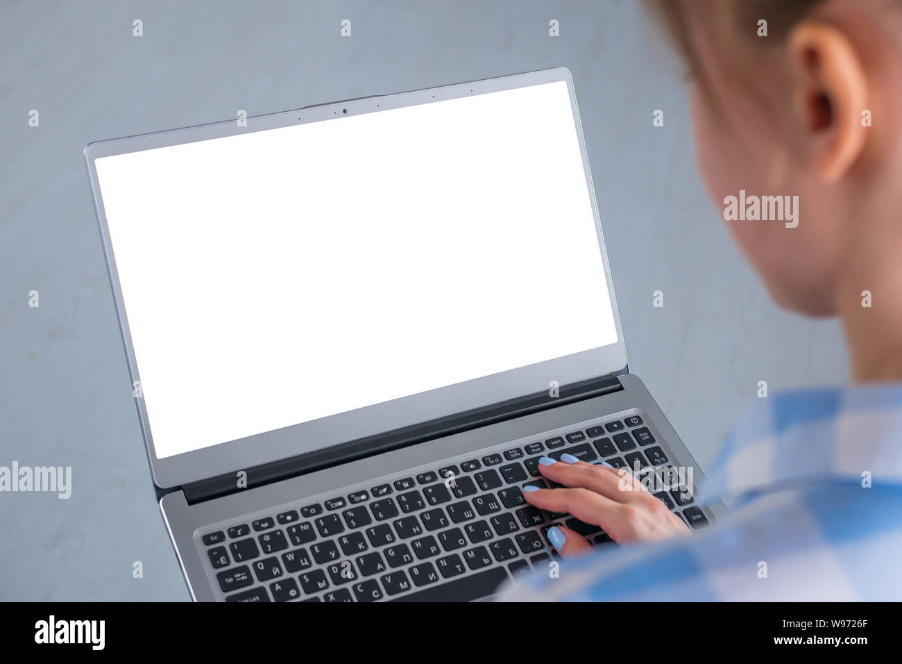 Woman freelancer typing on laptop computer keyboard with white blank ...