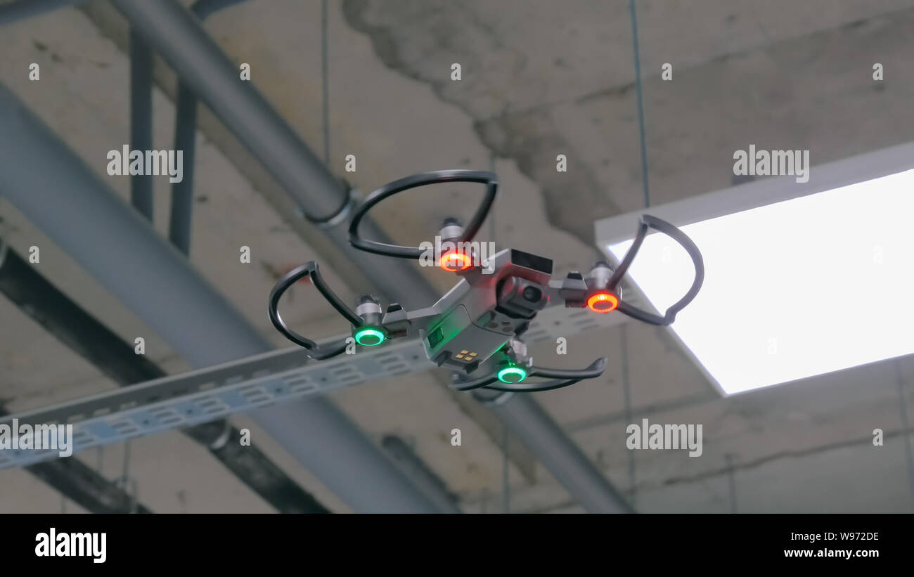 Drone with red light flying indoor Stock Photo - Alamy
