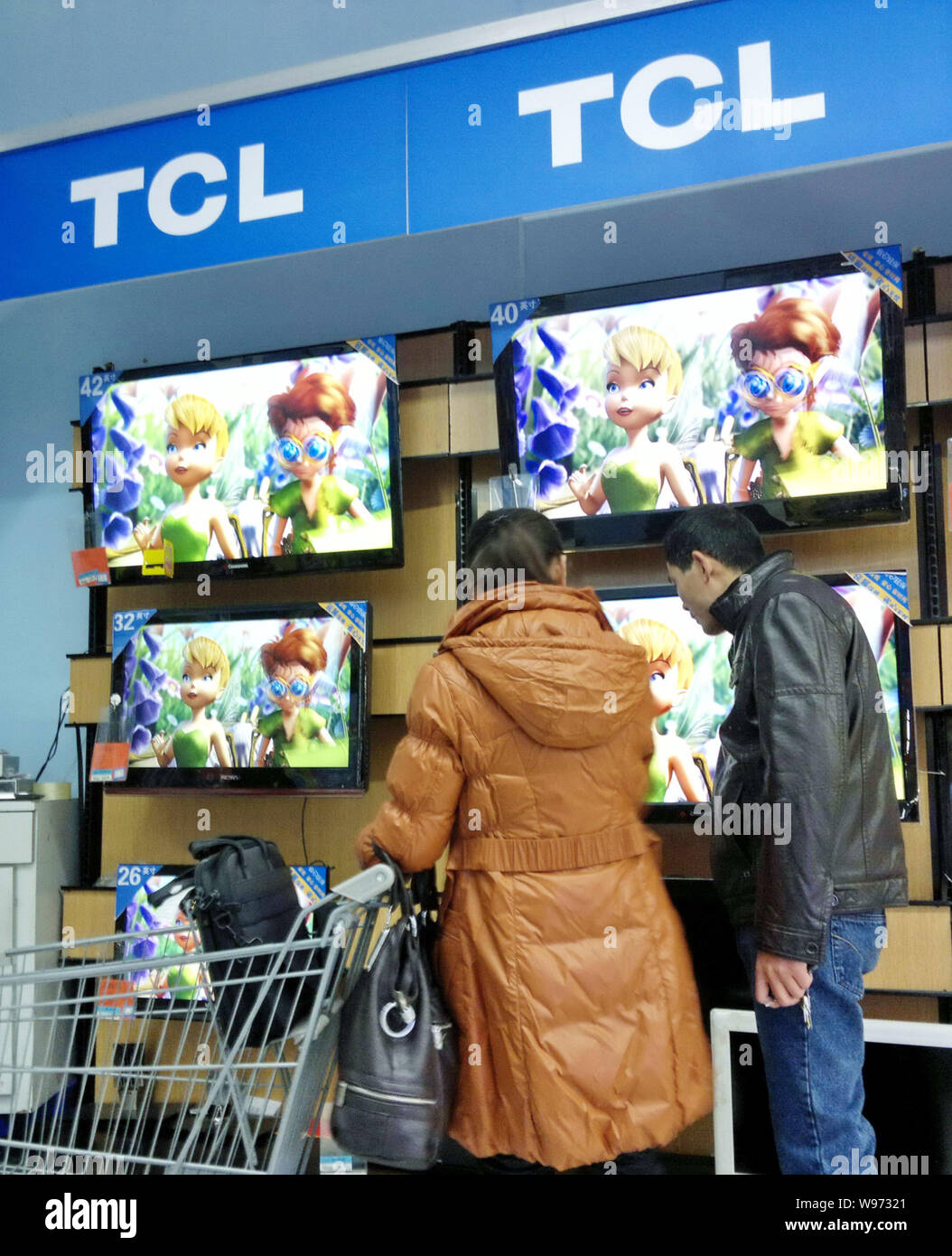--FILE--Chinese customers shop for TCL LCD televisions at a supermarket ...