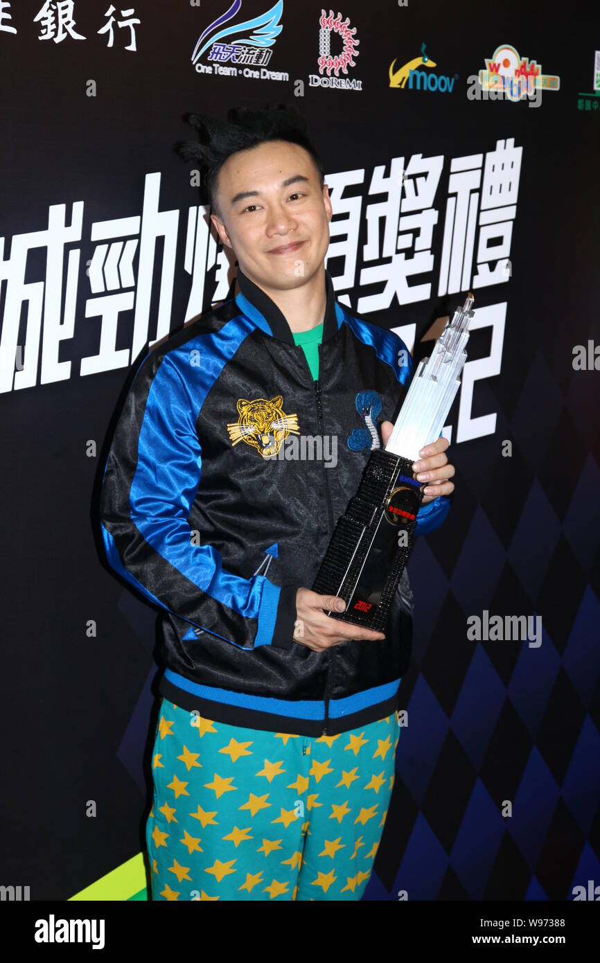 Hong Kong singer and actor Eason Chan shows his award of the best male ...
