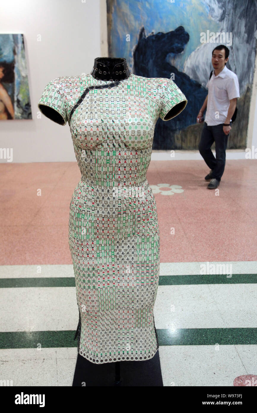 A visitor looks at an artwork during the SH Contemporary art exhibition ...