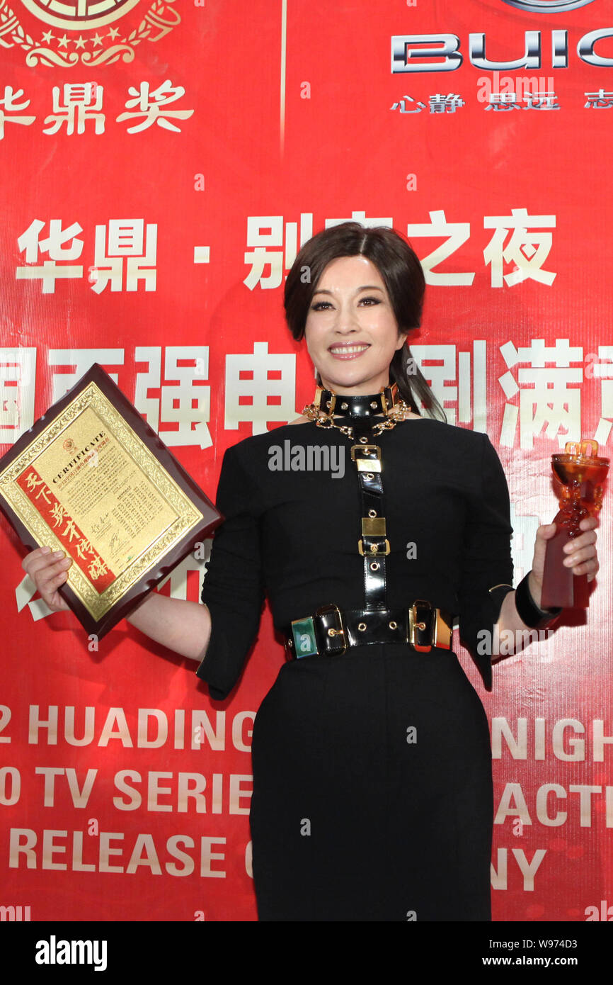 Chinese actress Liu Xiaoqing shows her award of The Audience Favorite ...