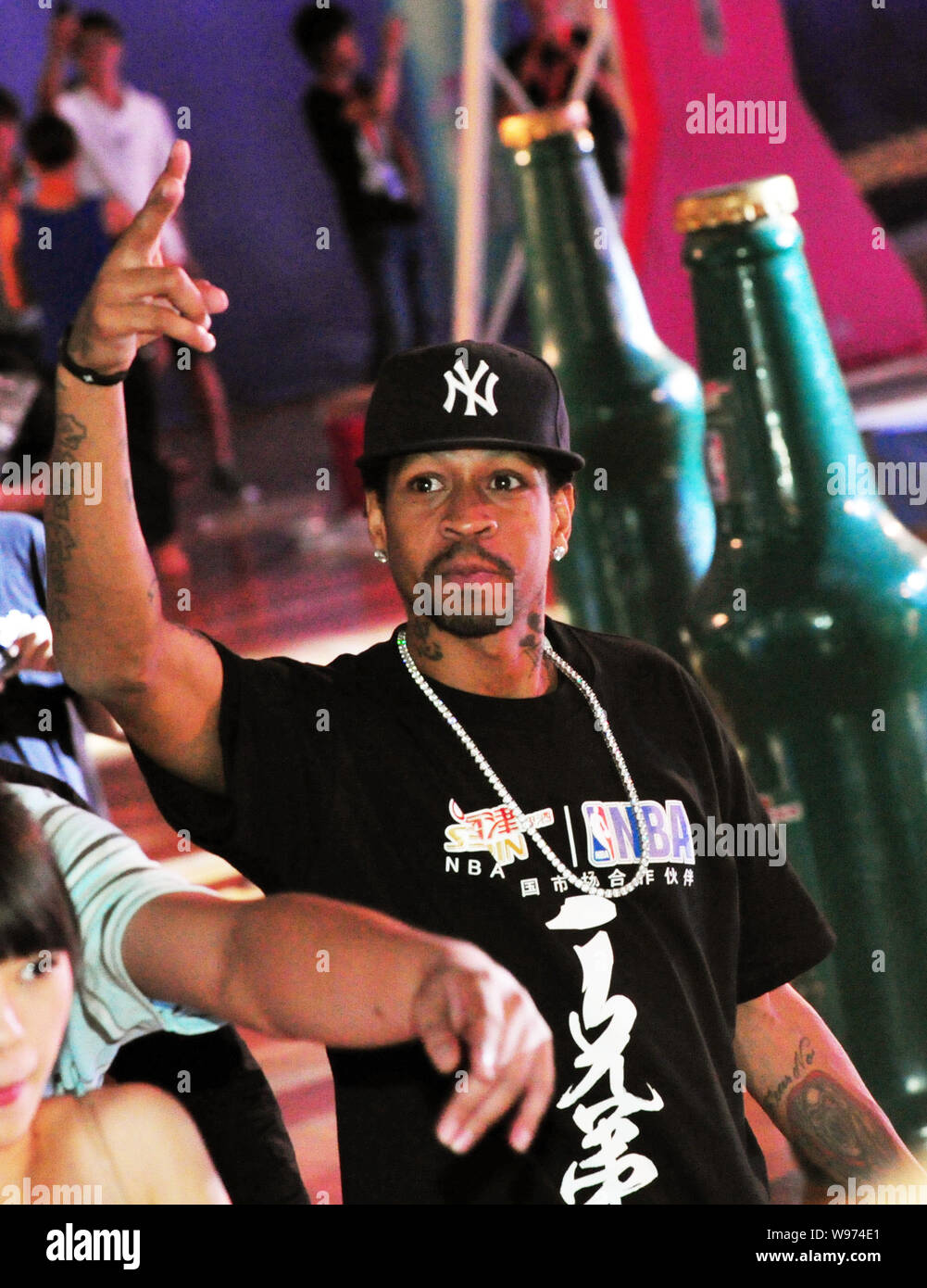 NBA superstar Allen Iverson gestures to fans at a promotional event by ...