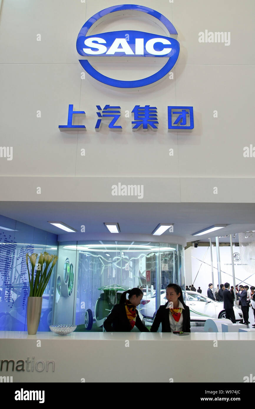 --File--Chinese staff are seen at the stand of SAIC during an auto show in Shanghai, China, 20 ...