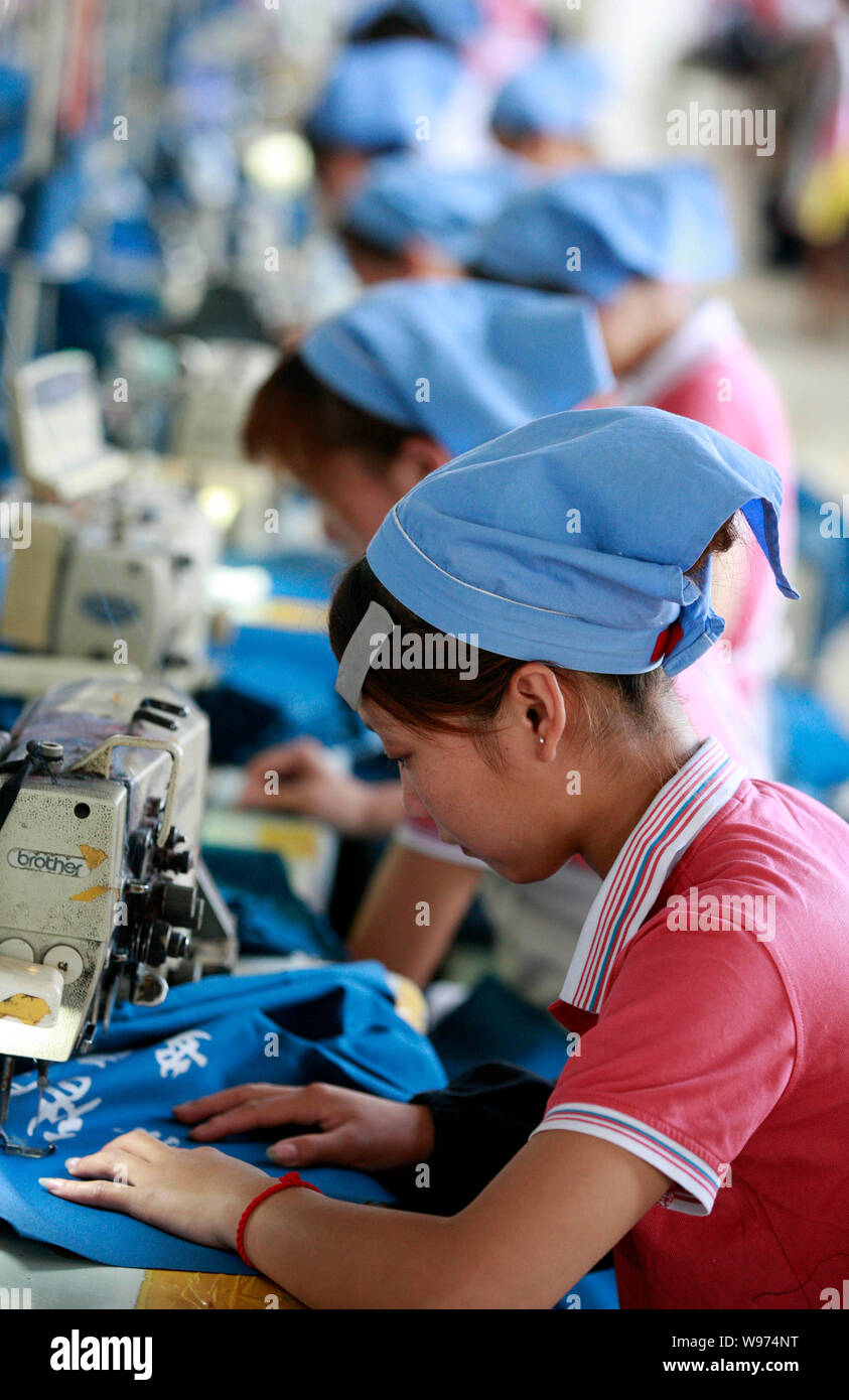 --FILE--Female Chinese workers sew clothes to be exported to Southeast Asia at a garment factory ...