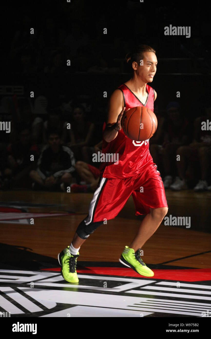 Hong Kong singer William Chan dribbles in a basketball match in Hong ...
