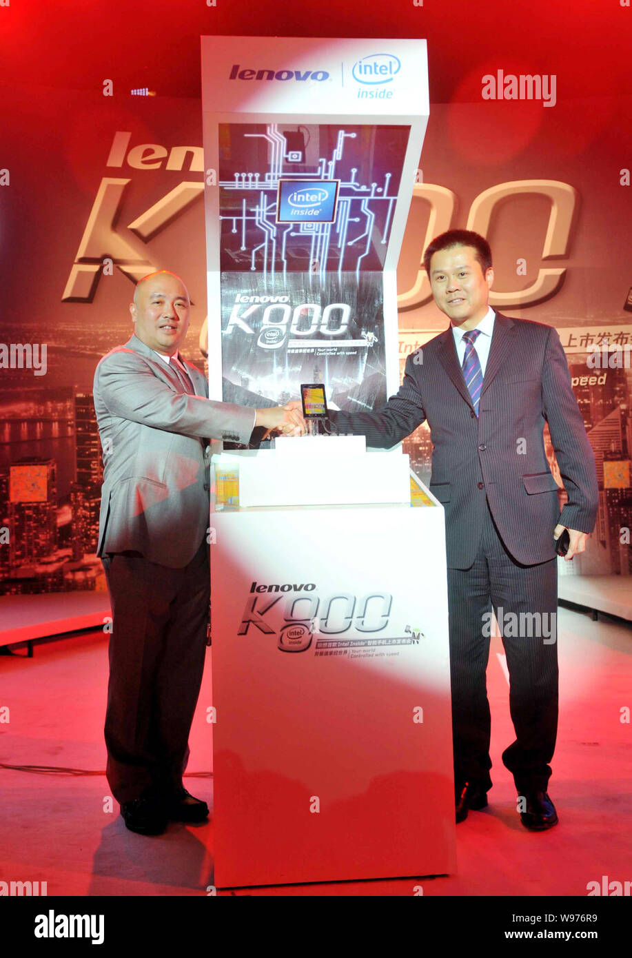 Chen Xudong, right, Senior Vice President of Lenovo, shakes hands with ...