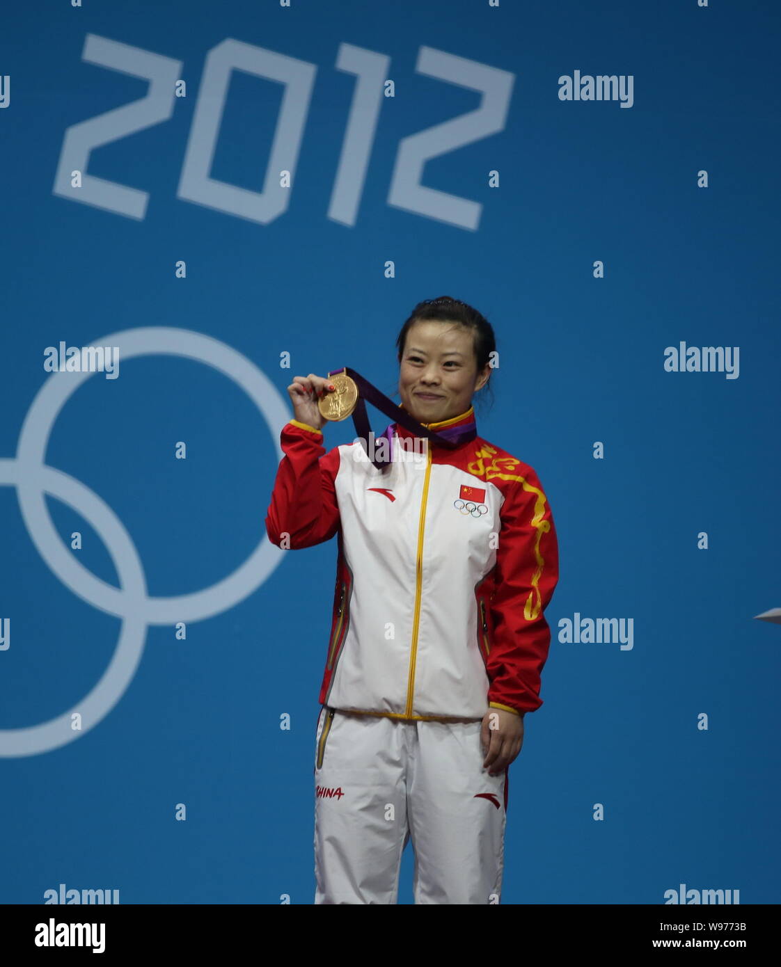 Gold medalist Wang Mingjuan of China shows her medal at the award ...