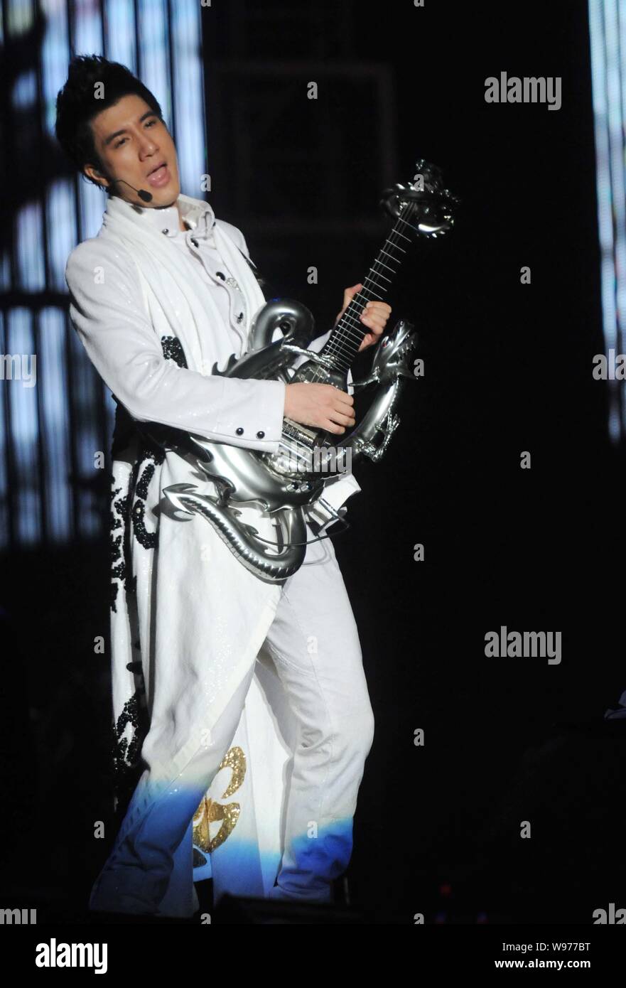 Taiwanese singer Lee-hom Wong plays guitar during his concert in ...