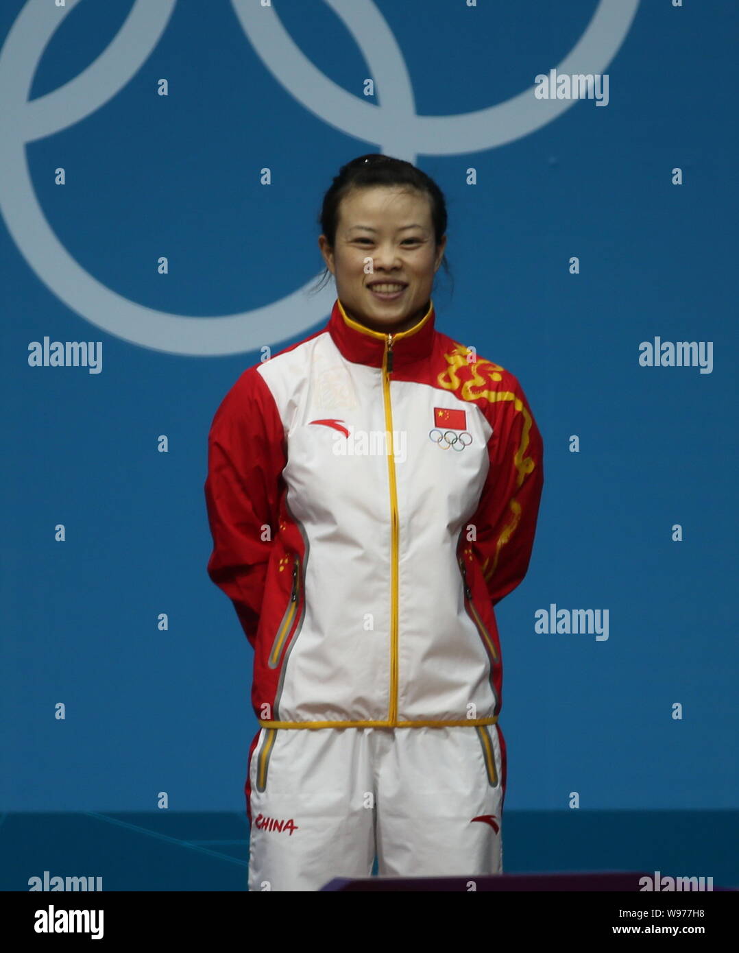 Gold medalist Wang Mingjuan of China poses at the award ceremony after ...