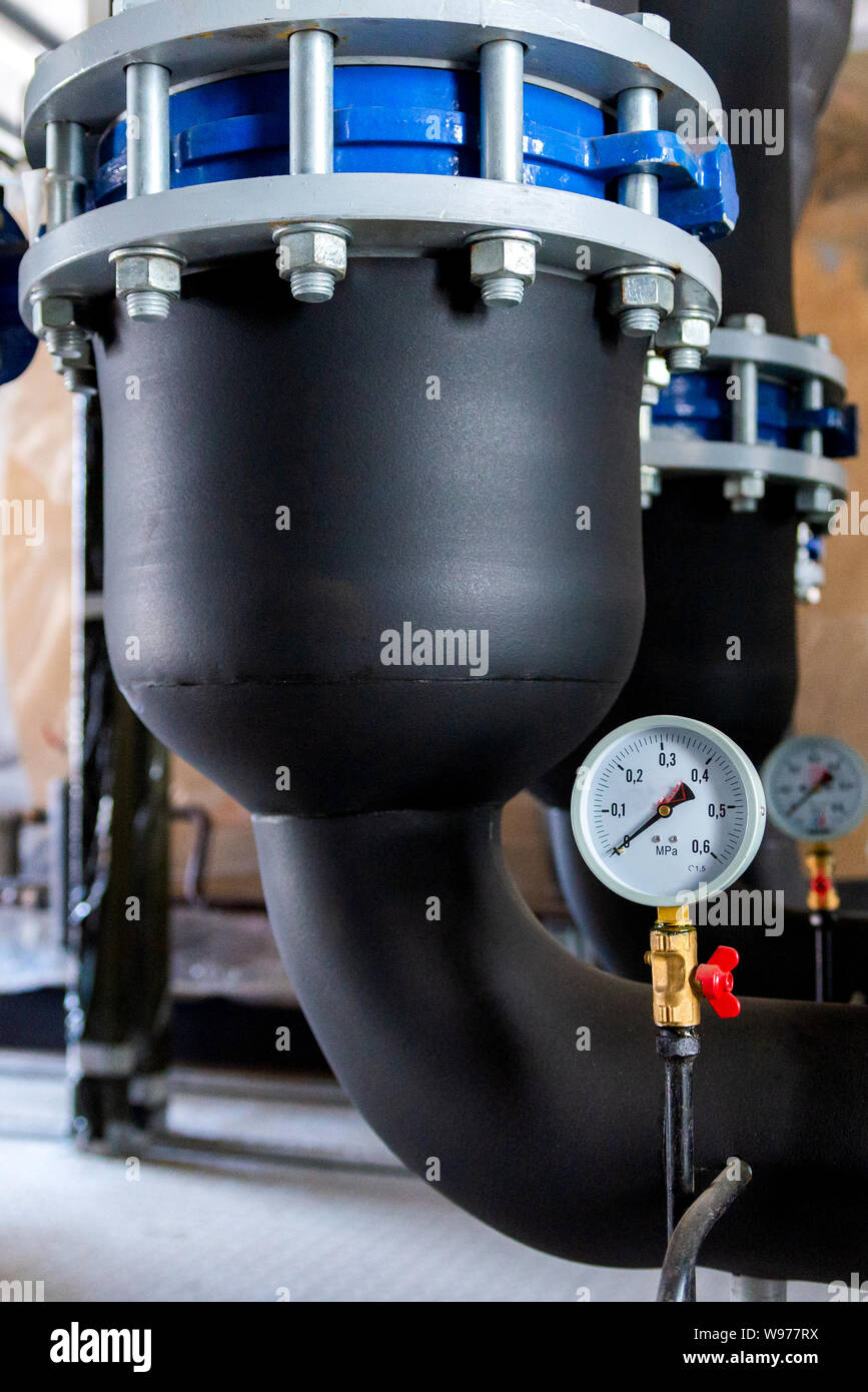 System of hot water pipes with manometer in boiler room Stock Photo - Alamy