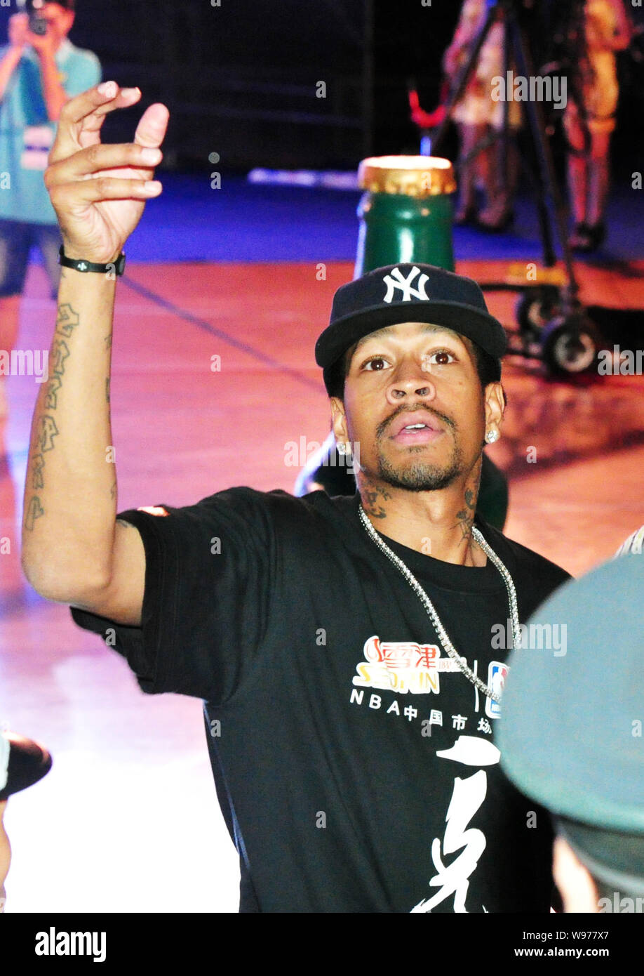 NBA superstar Allen Iverson gestures to fans at a promotional event by ...