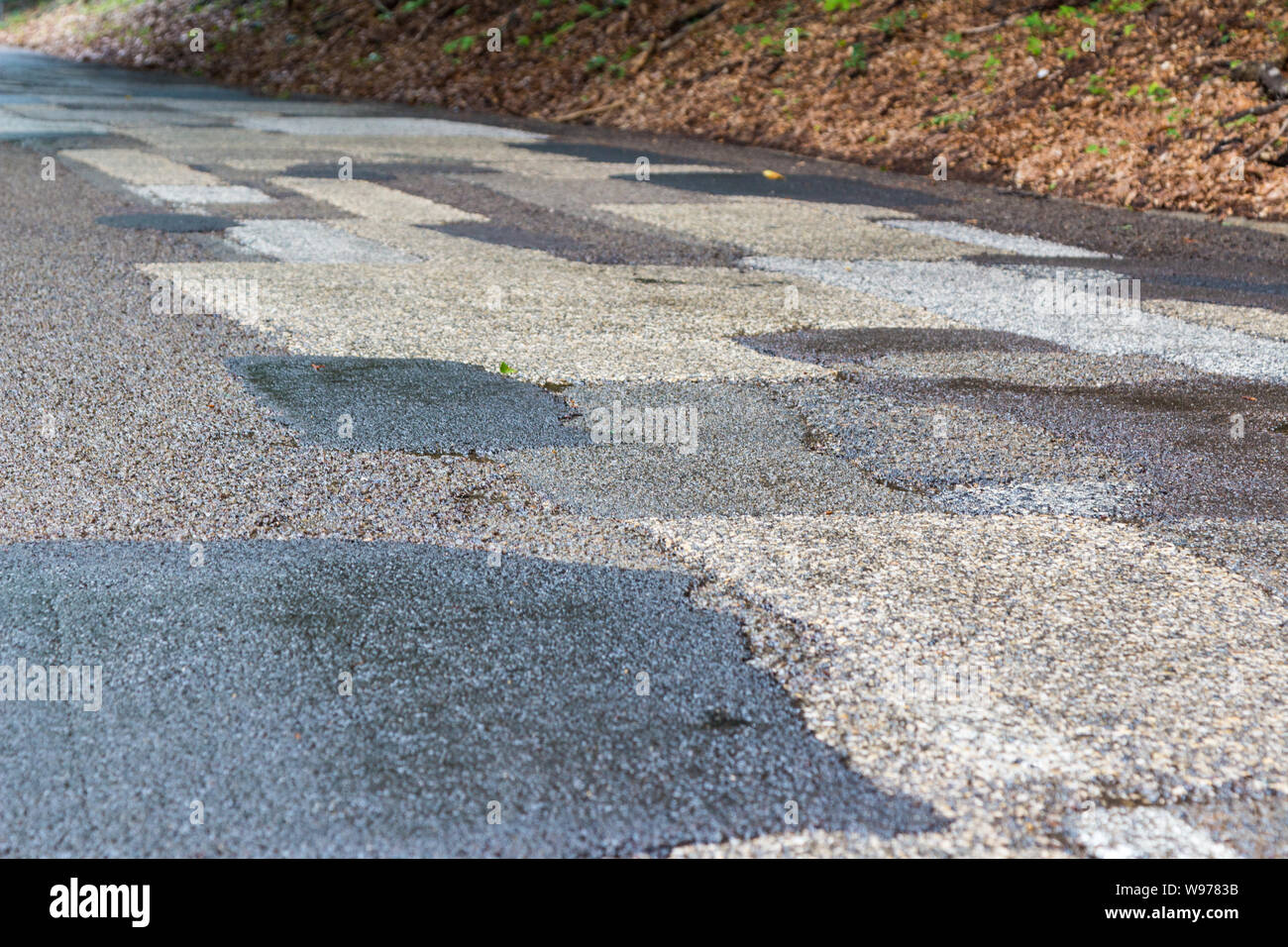 Repaired pothole patches in road, Matra Mountains, Hungary Stock Photo ...