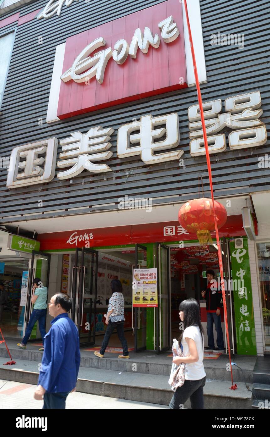 Pedestrians walk past a Gome home appliances chain store in Binzhou ...