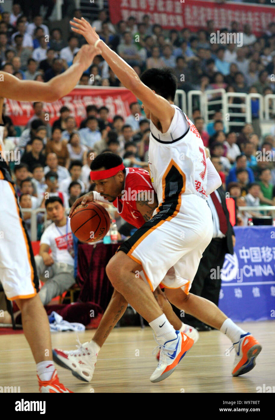 NBA star Allen Iverson of the US Pro-ball Legend, center, challenges Duan Jiangpeng of Shanxi ...