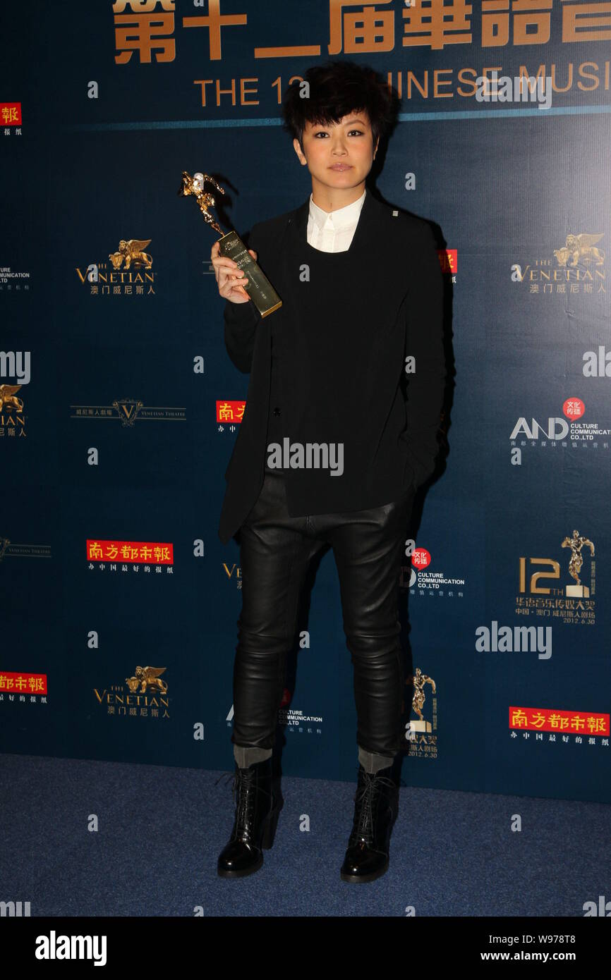 Hong Kong singer Denise Ho poses with a trophy at the press conference ...