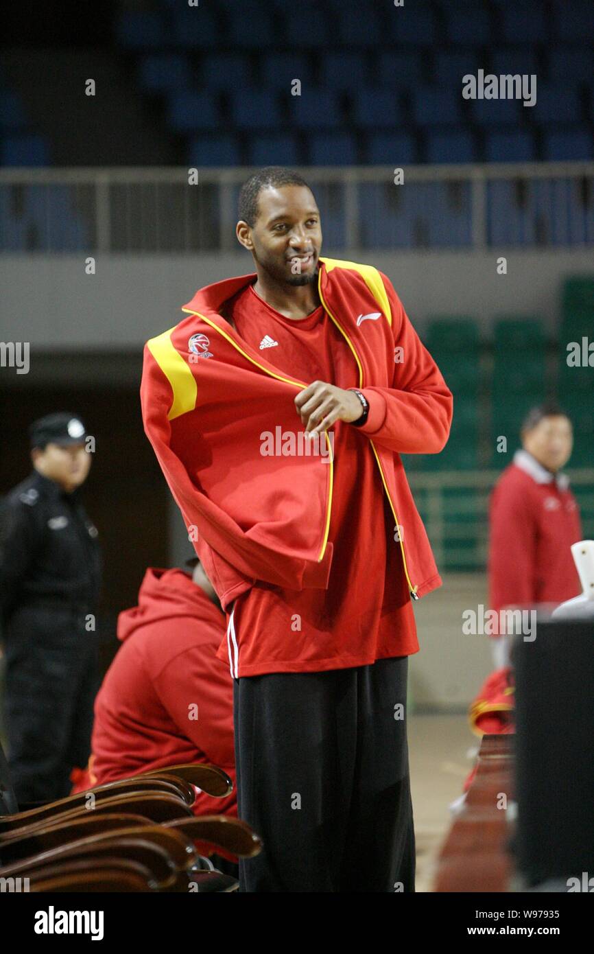 Tracy McGrady of the Qingdao Eagles puts on his clothes during a ...