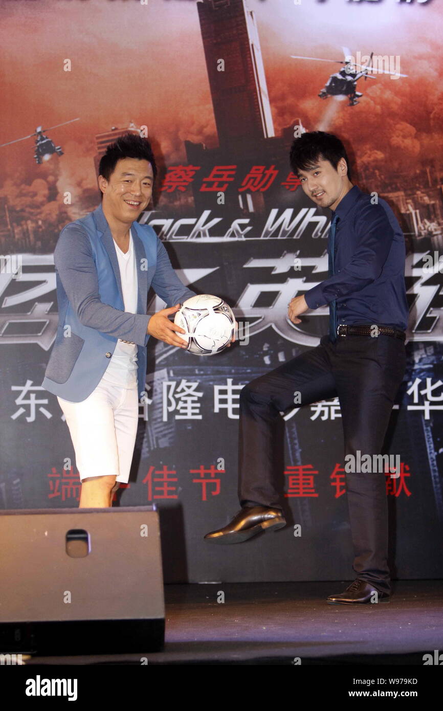 Chinese actor Huang Bo (L) and Taiwanese actor Mark Chao play football ...