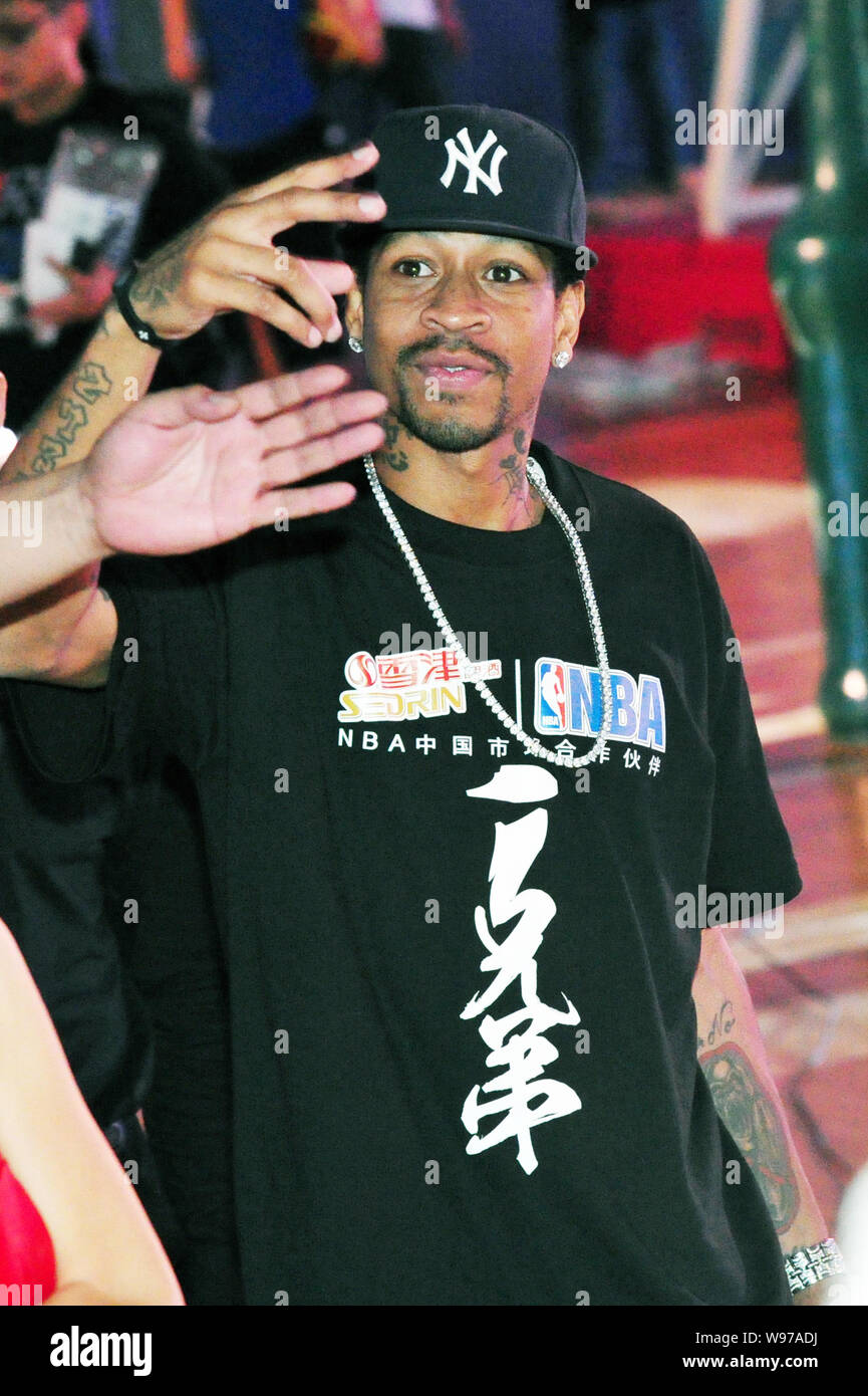 NBA superstar Allen Iverson gestures to fans at a promotional event by ...