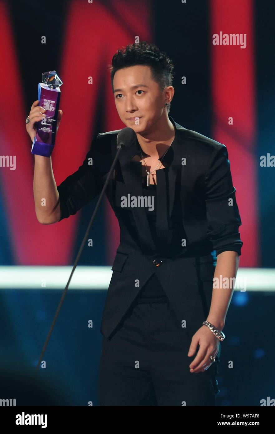 Chinese singer and actor Han Geng speaks after being awarded the trophy ...