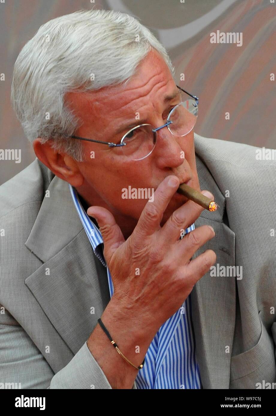 Head coach Marcello Lippi of Chinas Guangzhou Evergrande FC smokes ...