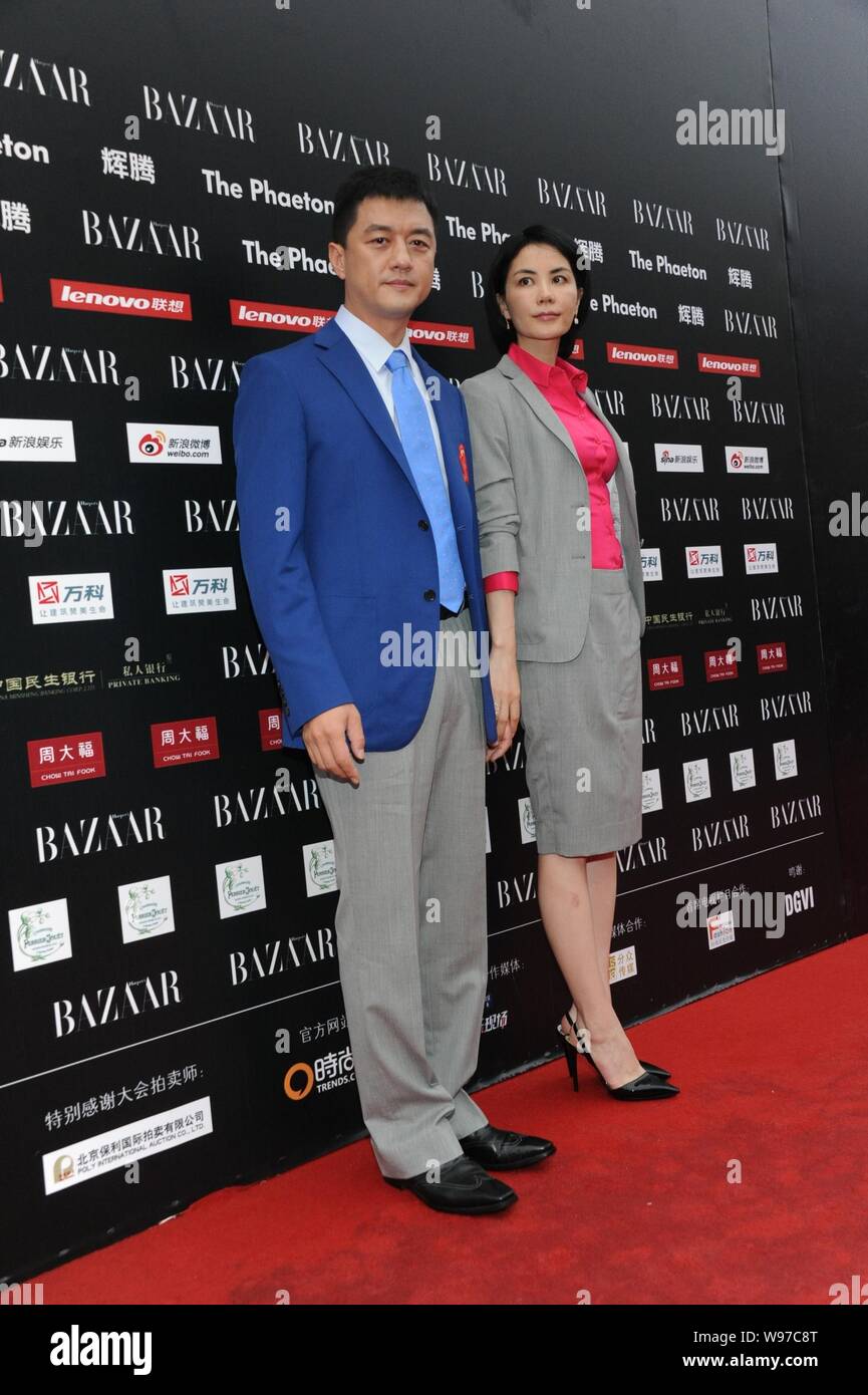 Hong Kong singer Faye Wong, right, and her actor husband Li Yapeng pose on the red carpet as ...