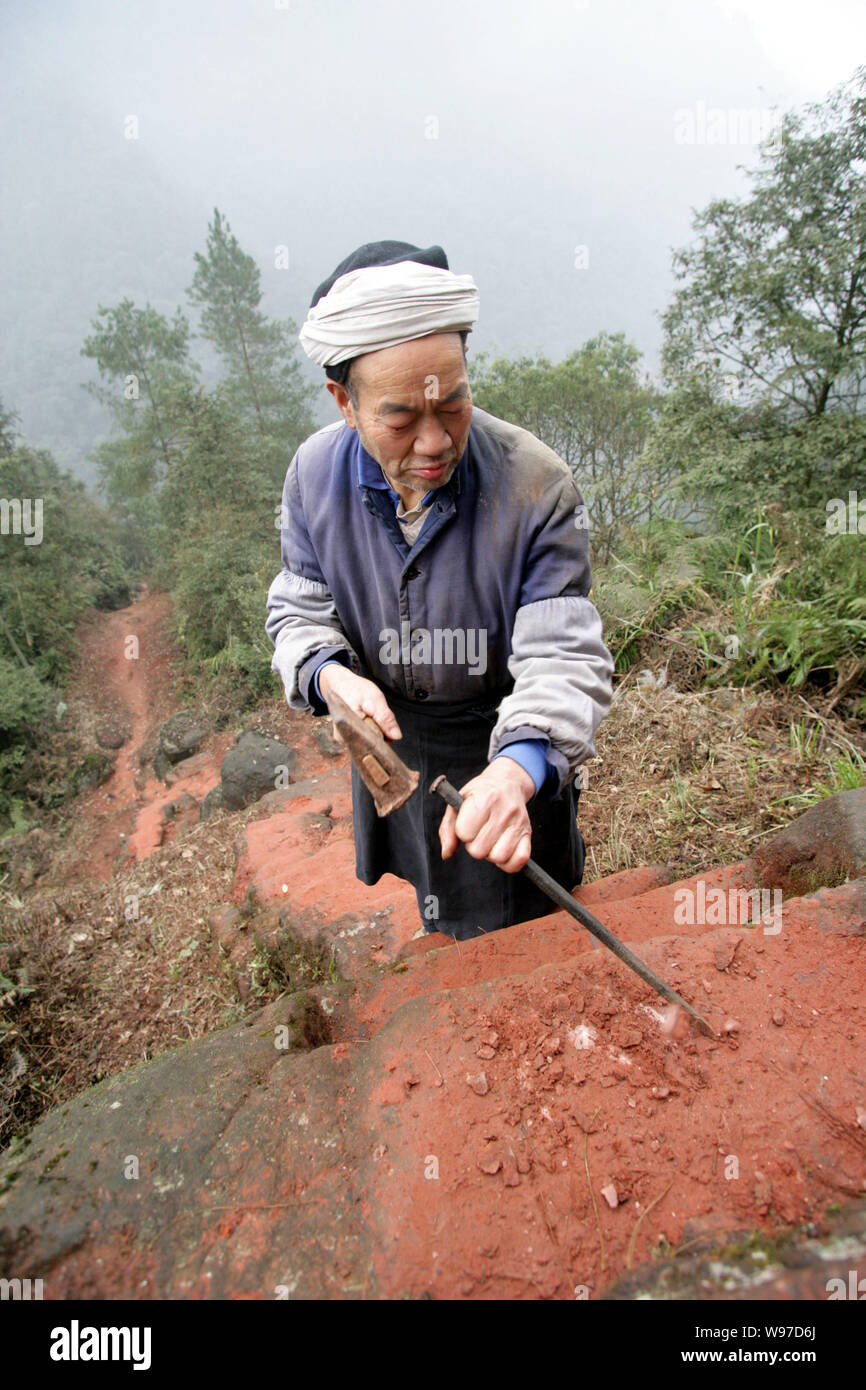 --FILE--Chinese man Liu Guojiang repairs a stair of the Love Ladder ...