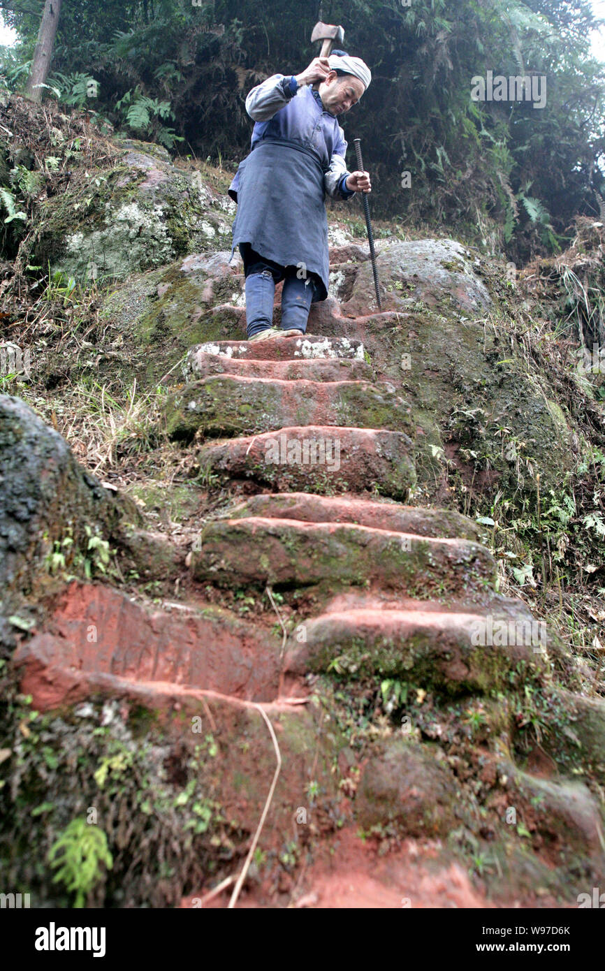 --FILE--Chinese man Liu Guojiang repairs a stair of the Love Ladder ...