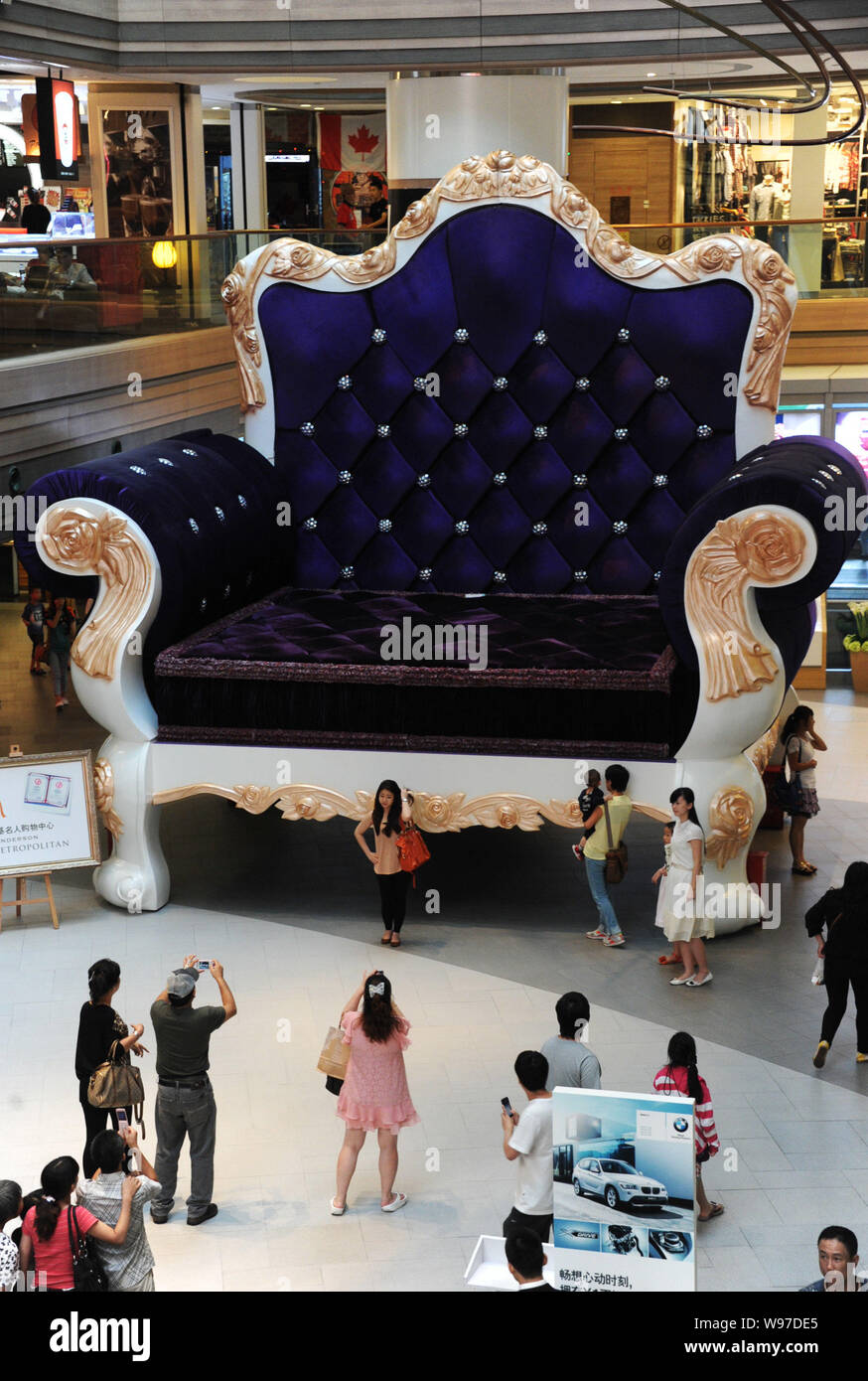 Shoppers pose in front of the worlds biggest sofa at a mall in Shanghai ...