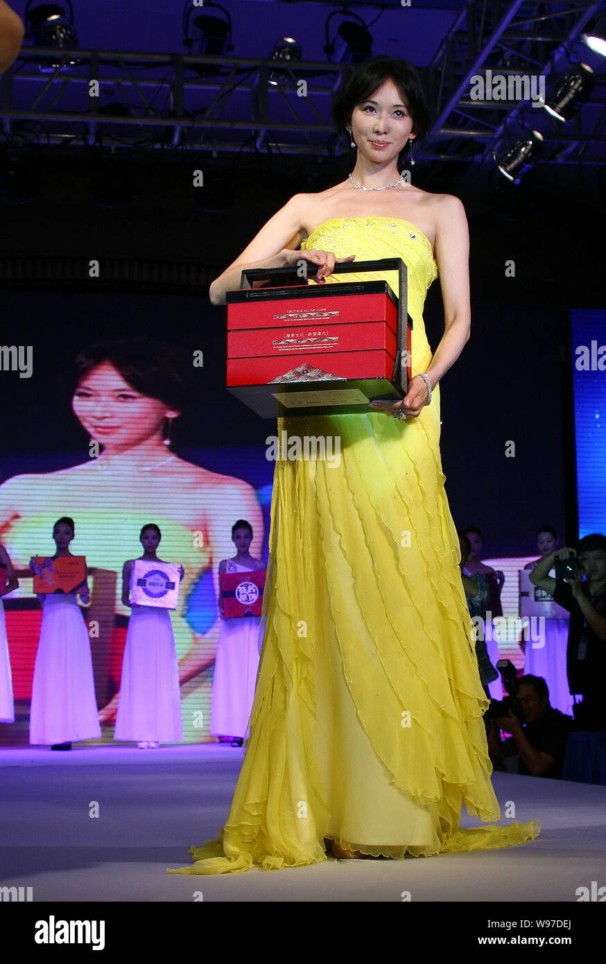 Taiwanese model and actress Lin Chi-ling (yellow) poses during a ...