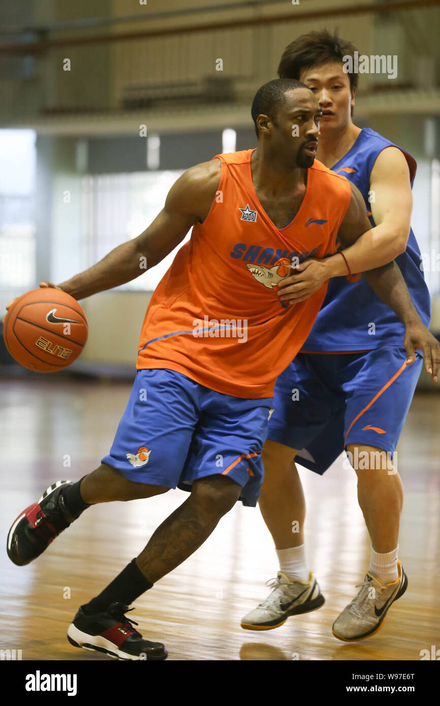 Gilbert Arenas of the Shanghai Sharks, left, challenges a teammate ...