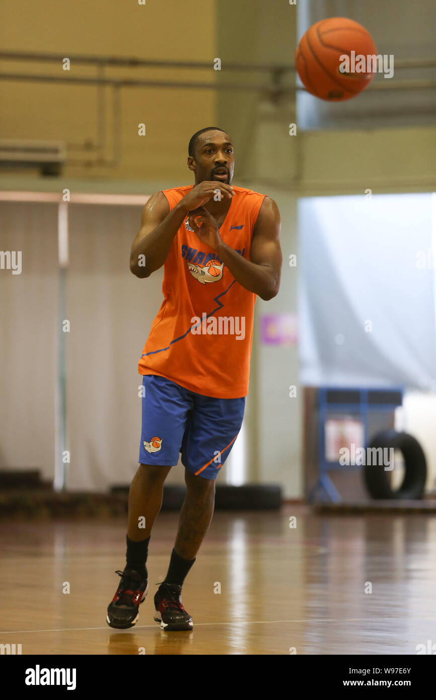 Gilbert Arenas of the Shanghai Sharks passes the ball to a teammate ...