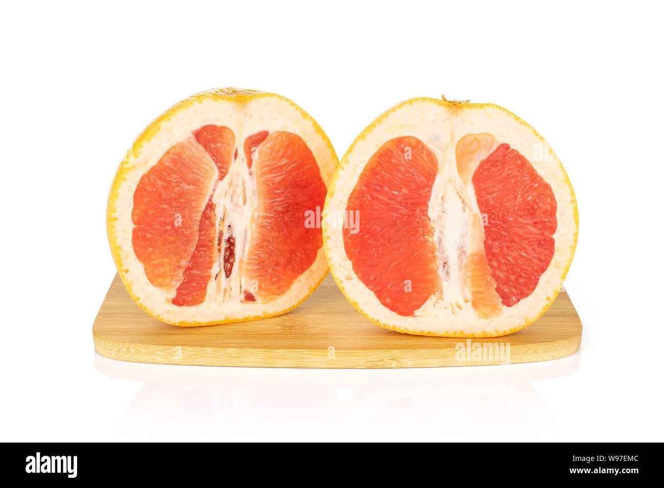 Group of two halves of fresh pink grapefruit on bamboo cutting board ...