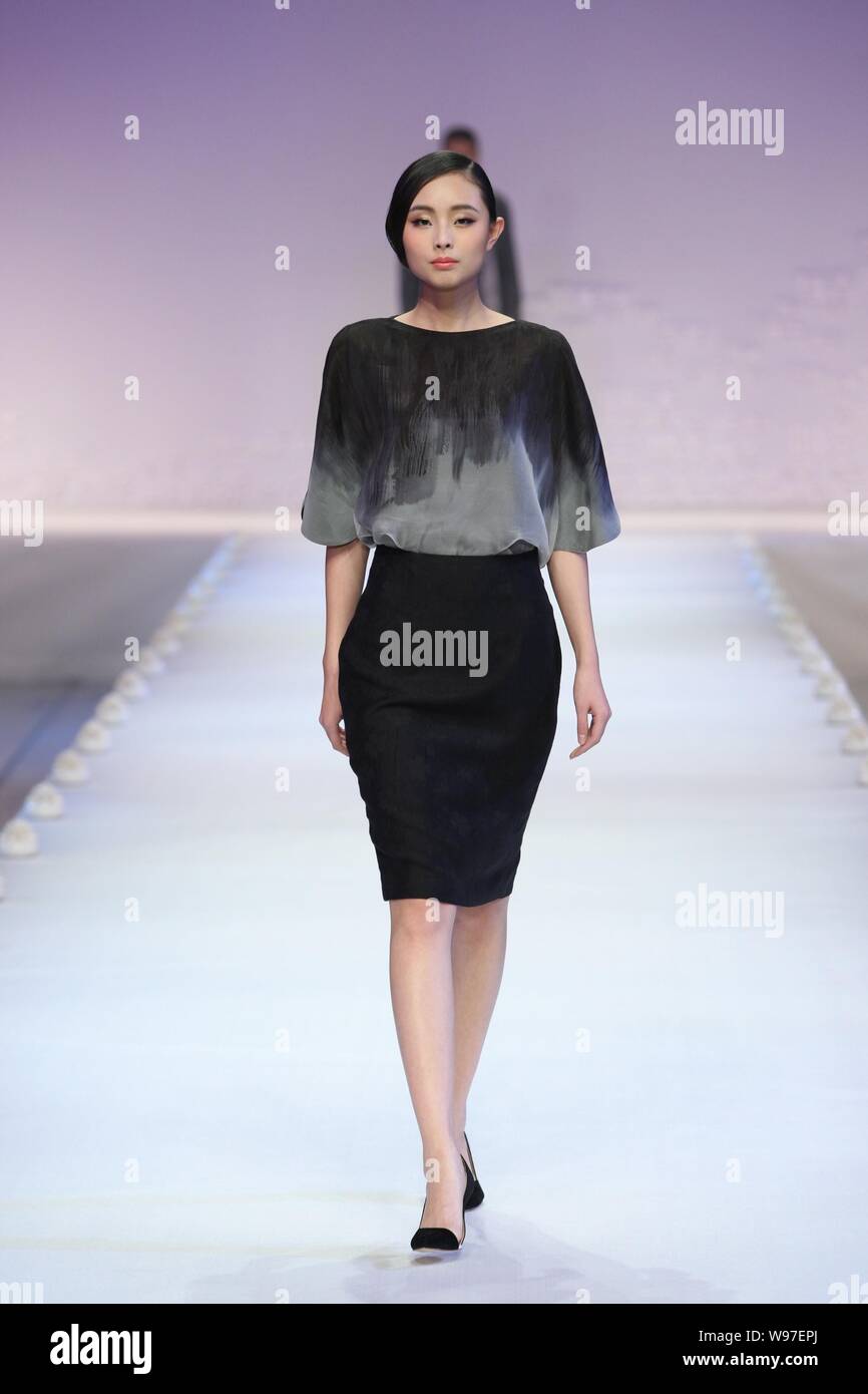 A model displays a new creation by designer Chu Yan in her fashion show ...