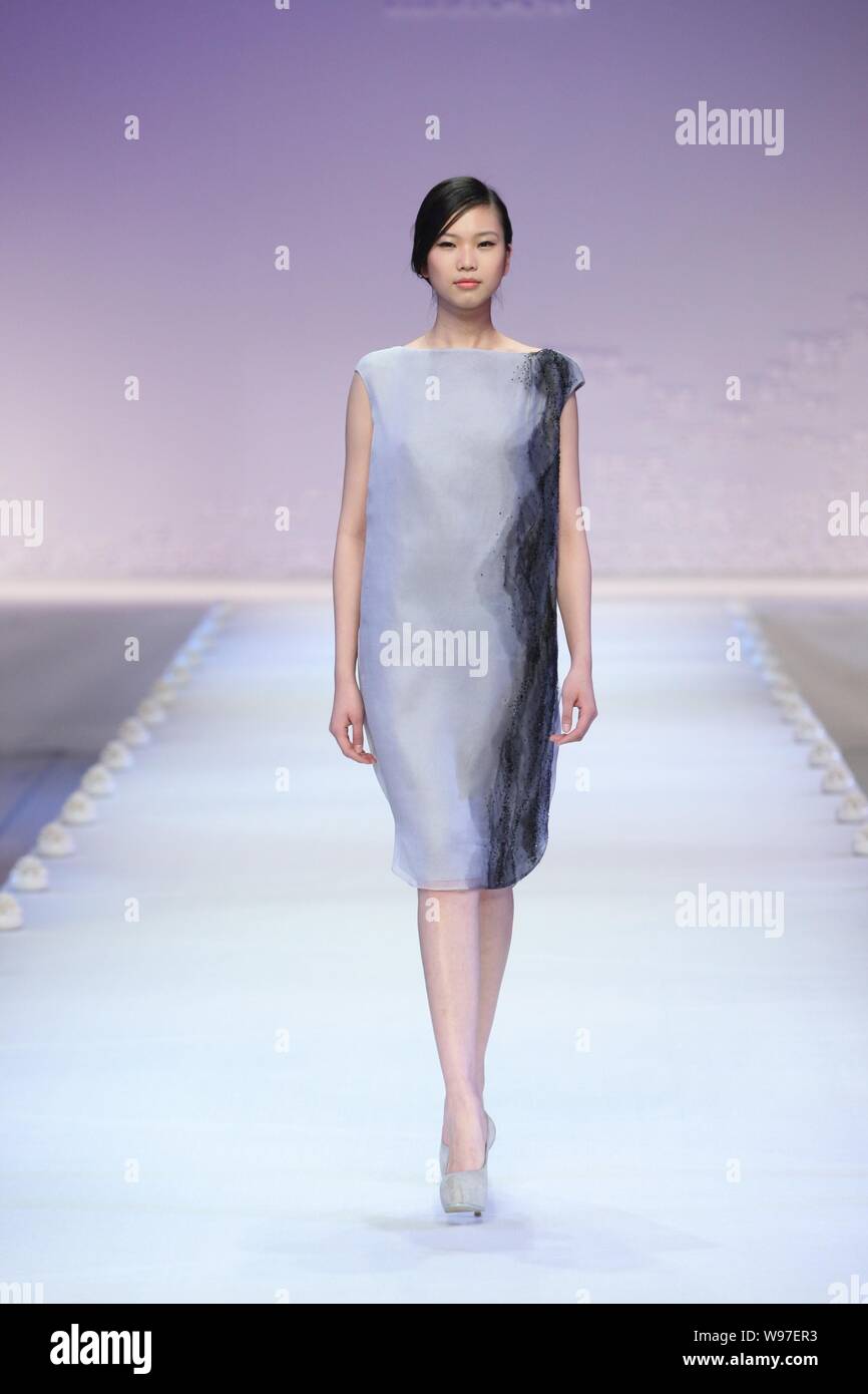 A model displays a new creation by designer Chu Yan in her fashion show ...