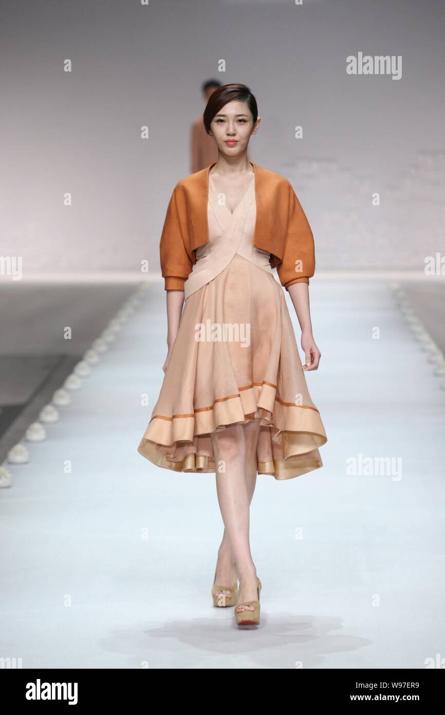 A model displays a new creation by designer Chu Yan in her fashion show ...