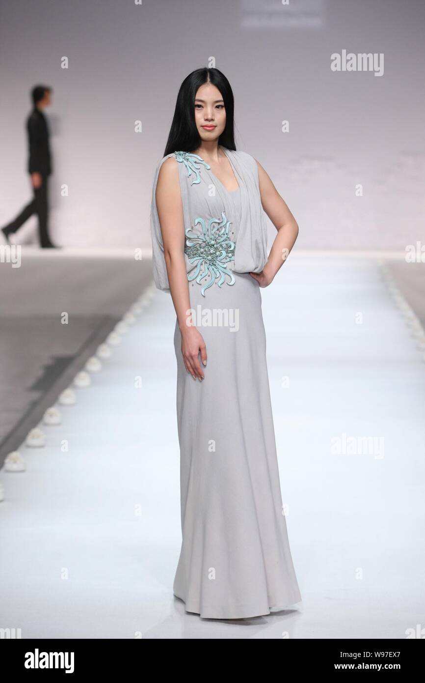 A model displays a new creation by designer Chu Yan in her fashion show ...